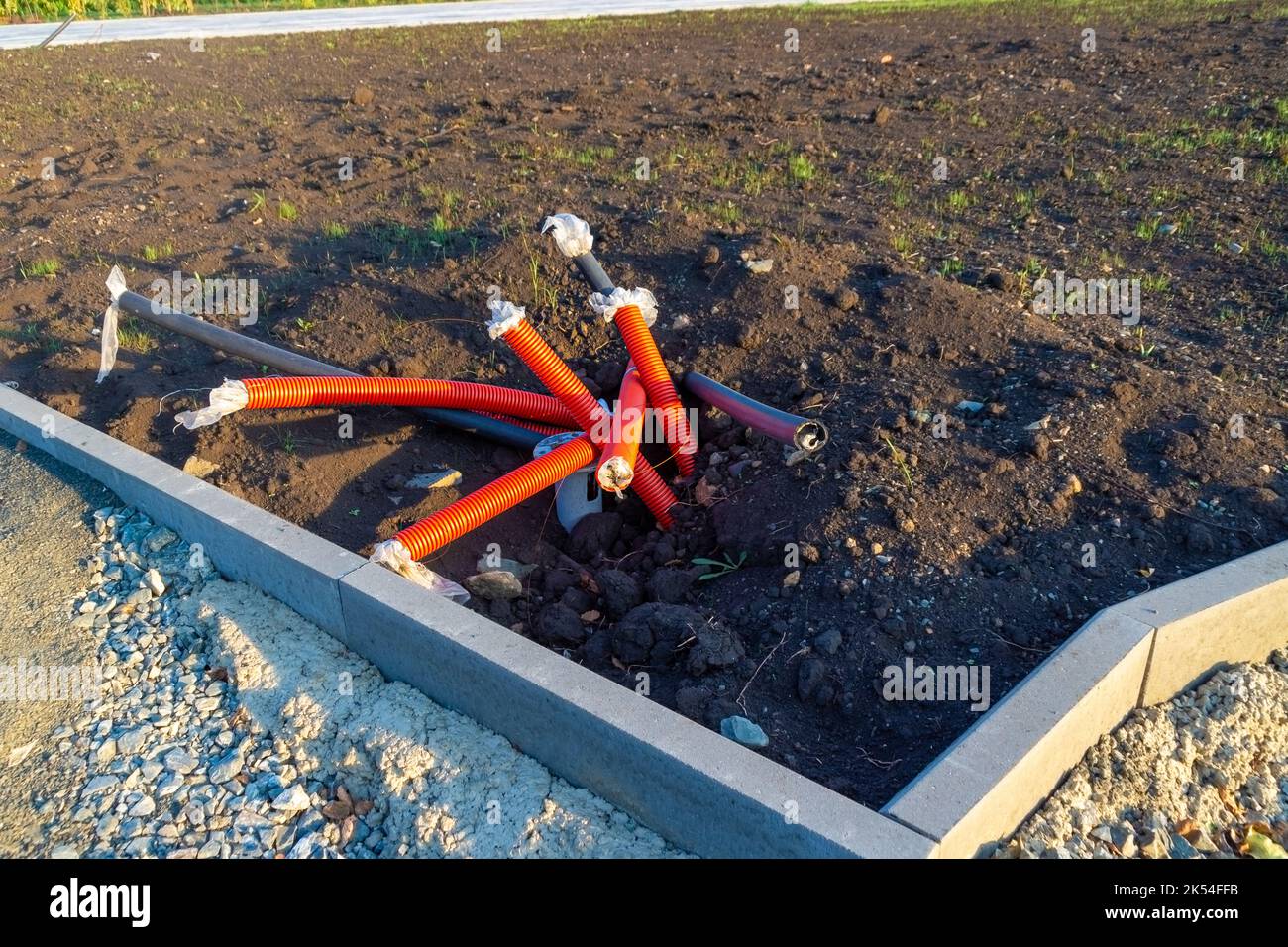 park reconstruction - red and black protective cable corrugations ...