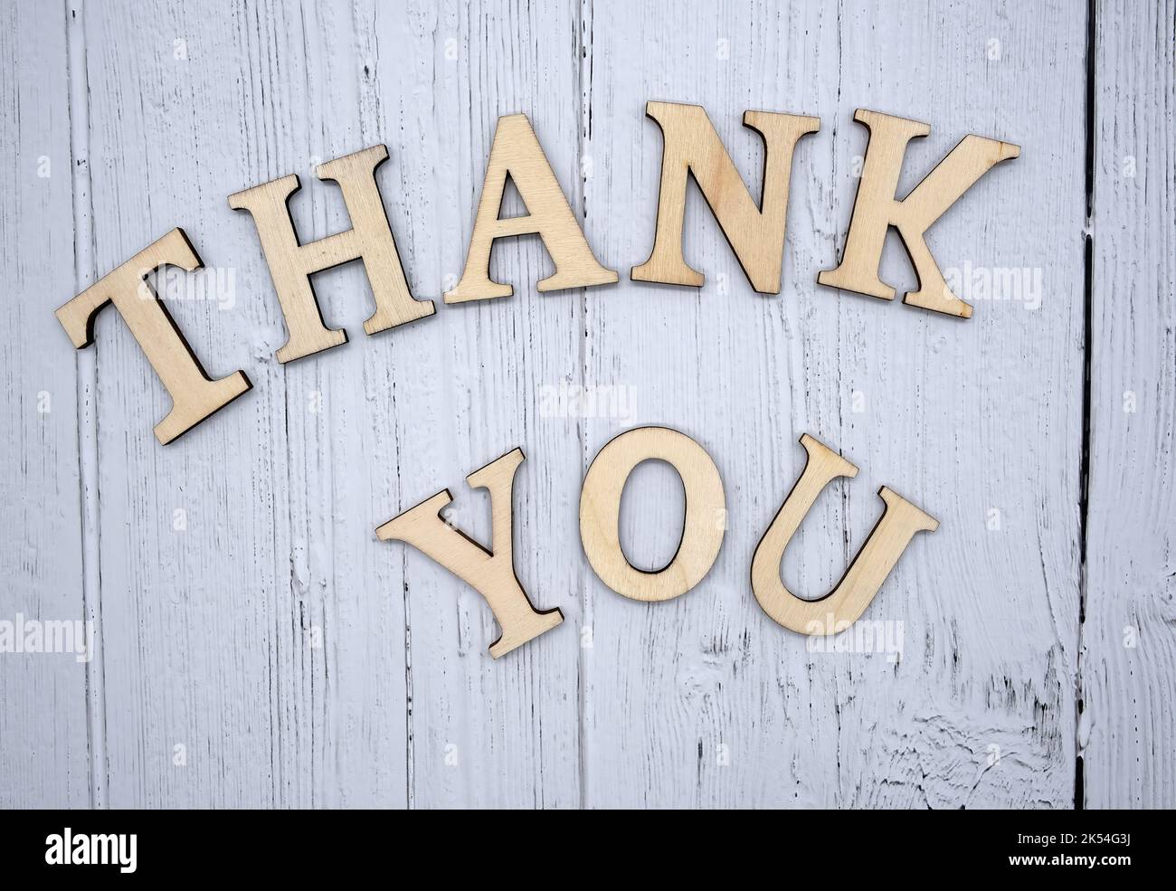 The words THANK YOU written in wooden letters on white wooden ...