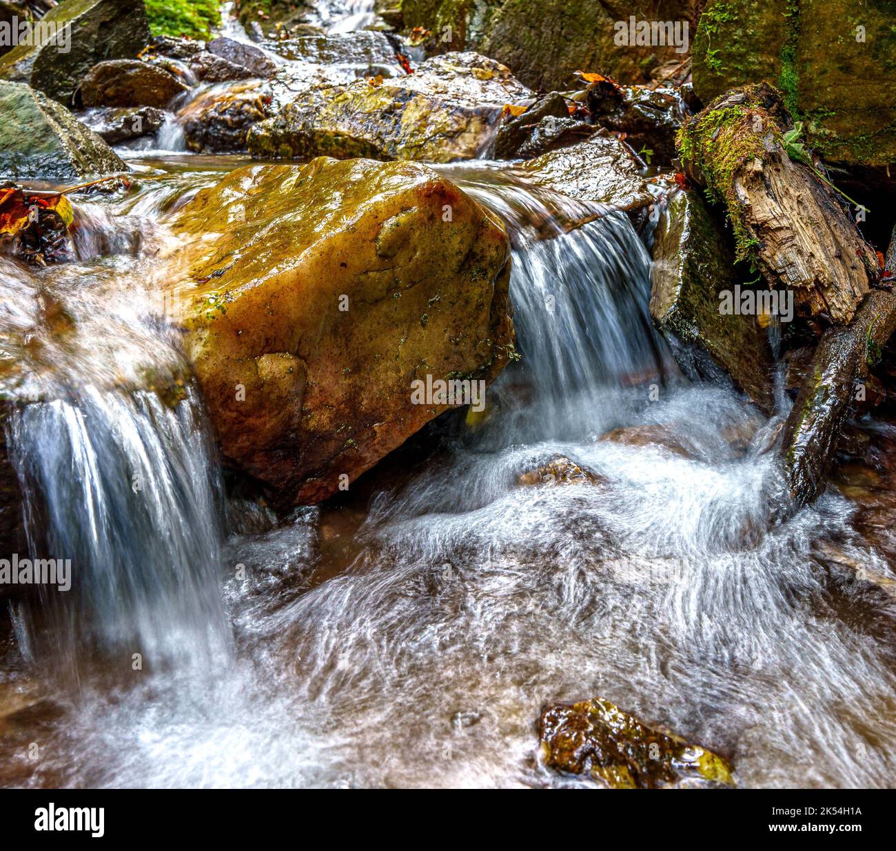 A flowing waterfall falling from rocks Stock Photo - Alamy