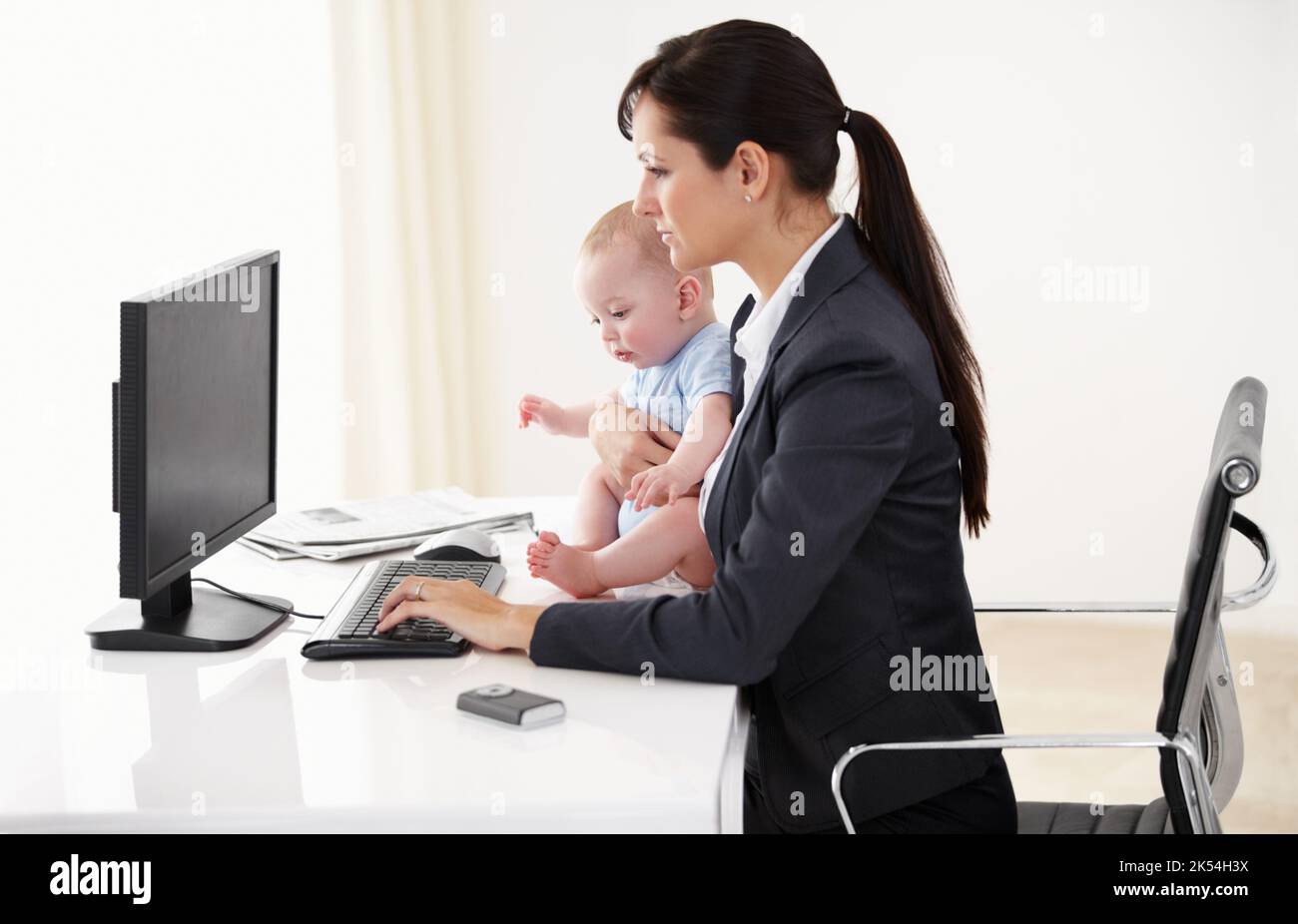 Daycare is indispensable to a working mom. Working mother holding a ...