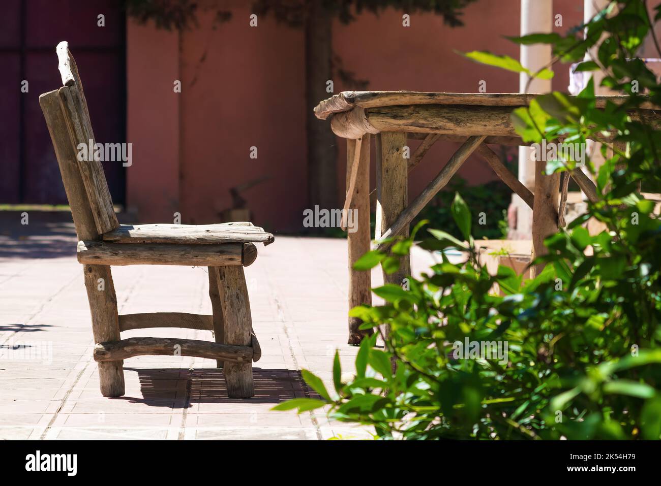 Old handmade wooden table with a bench Stock Photo - Alamy