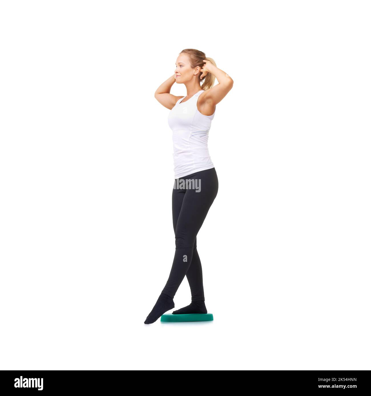 Focus on posture. Full length studio shot of a young woman doing ...