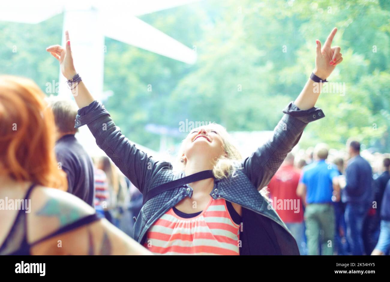 Slave to the music. a young female fan cheering at a music festival ...