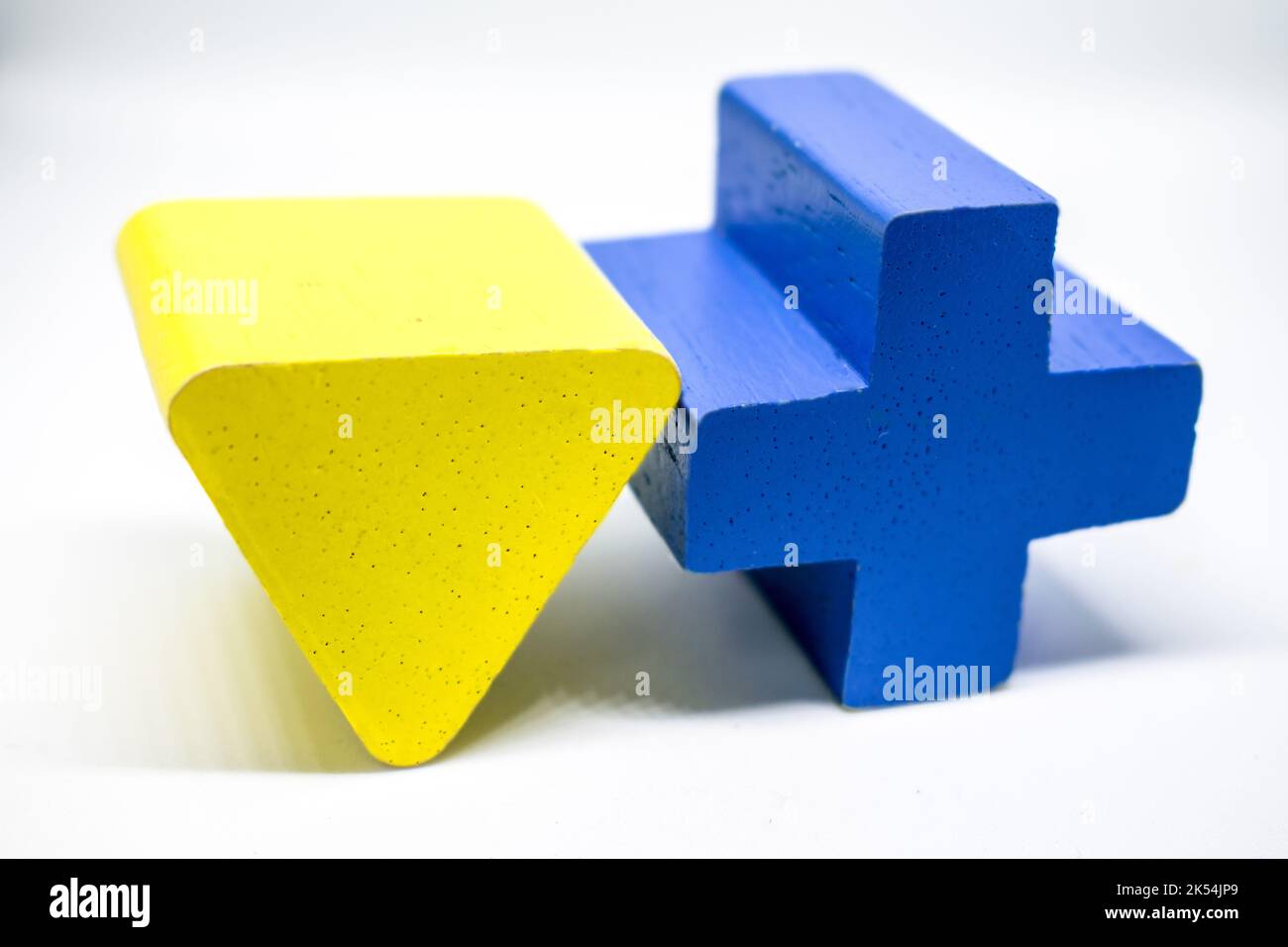 Cross and triagle geometry Made of wood laid on a white background ...