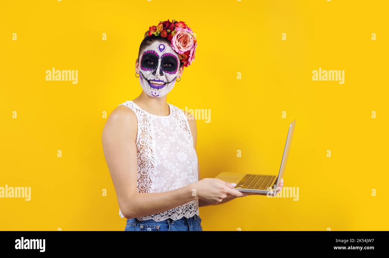 Mexican Catrina, portrait of young hispanic woman holding computer or ...