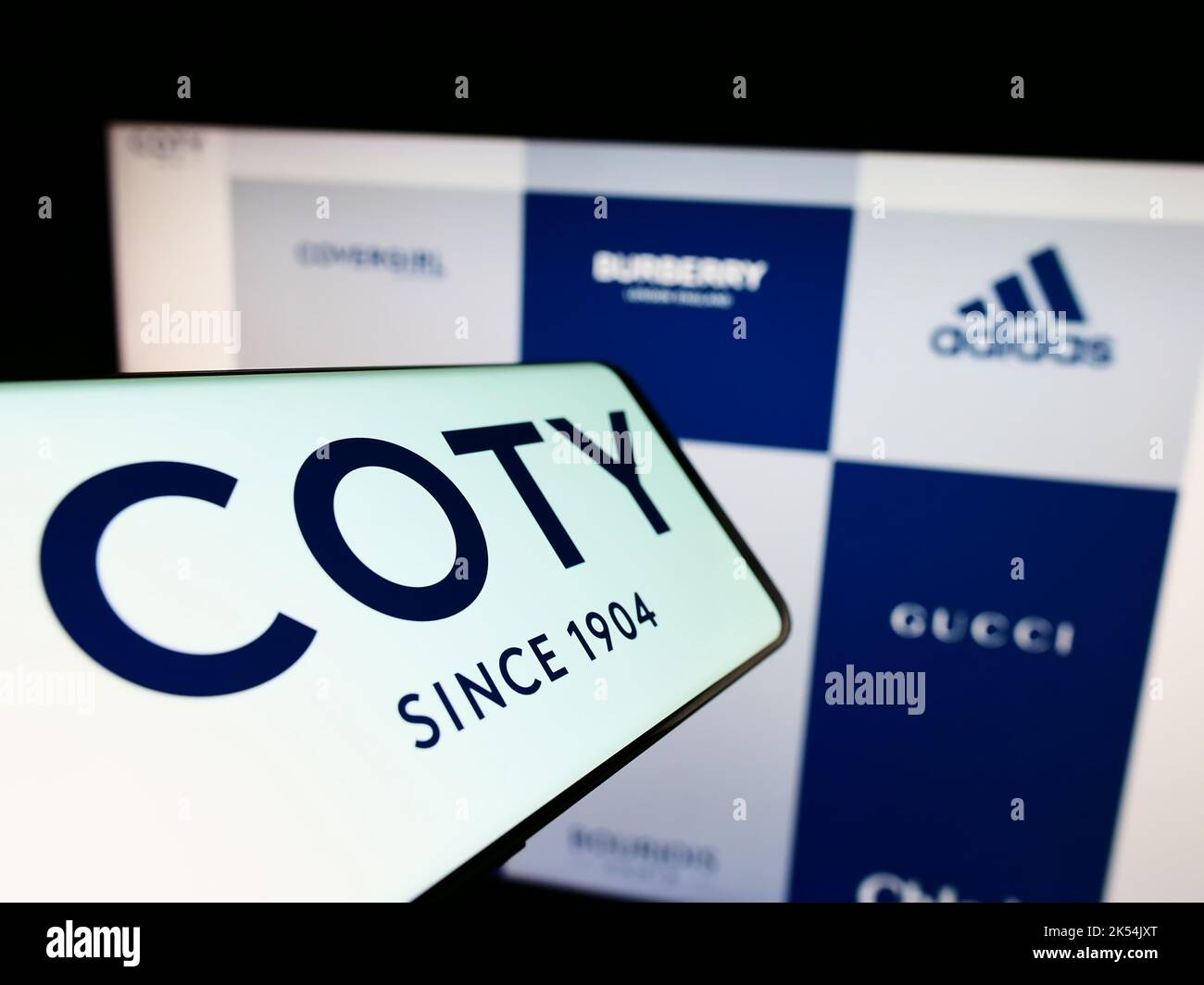 Mobile phone with logo of American beauty company Coty Inc. on screen ...