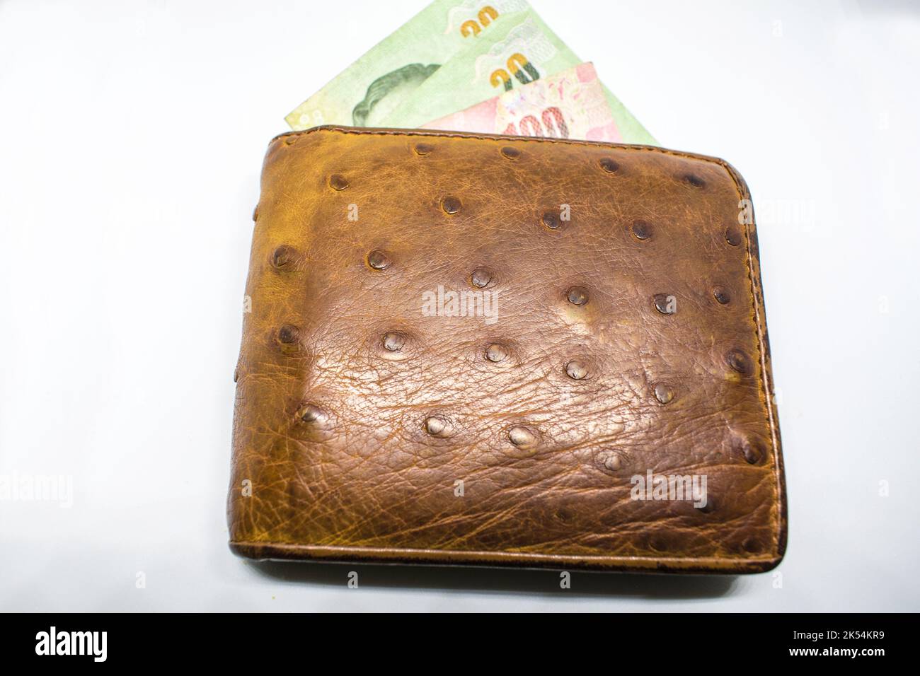 men's brown wallet money in cash white background Stock Photo - Alamy