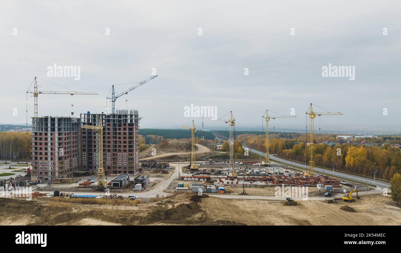 Construction site in autumn. Lots of construction cranes. Overcast ...