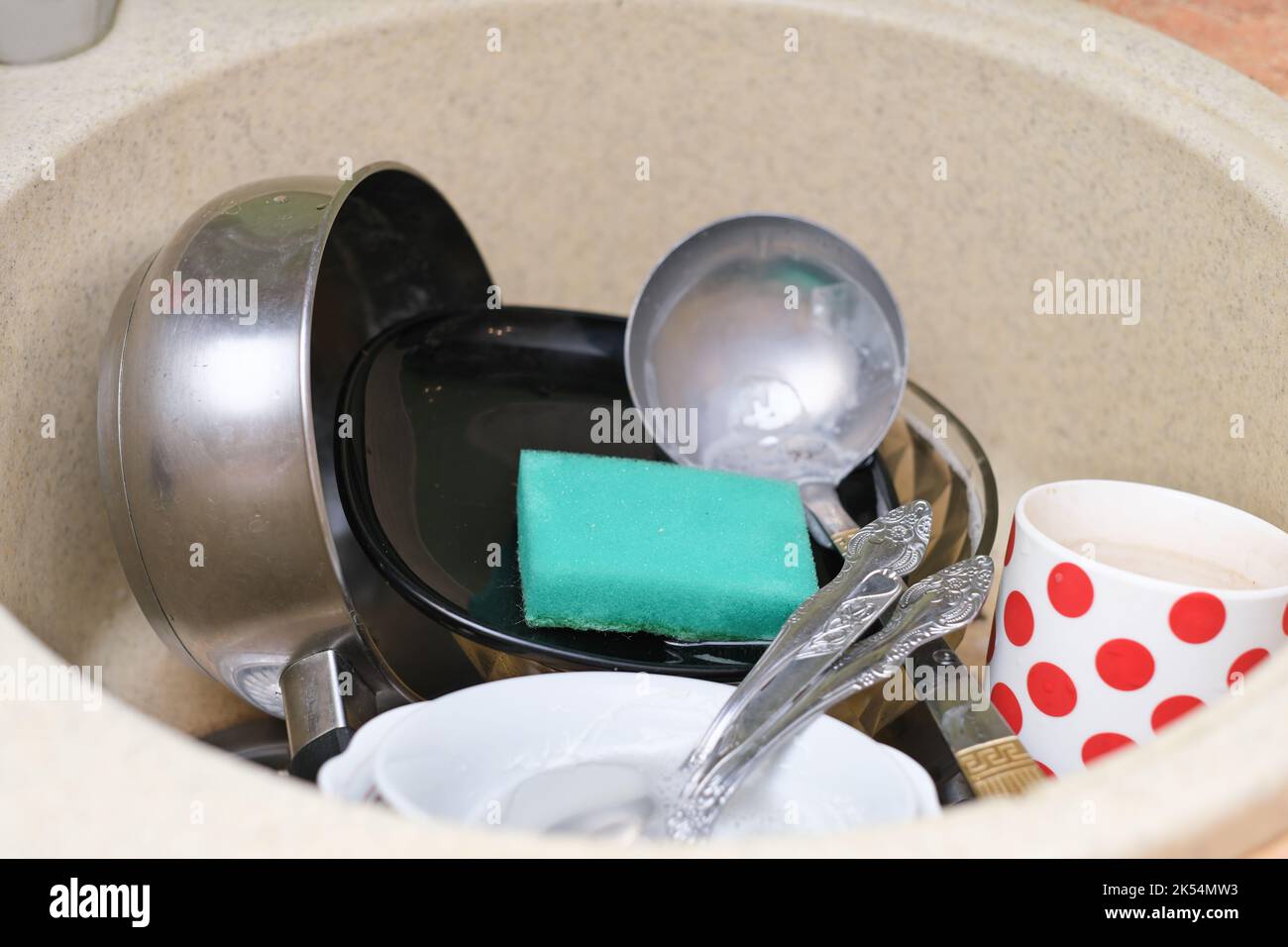 dirty dishes and kitchen utensils in a sink. messy kitchen. cluttered ... dirty dishes and kitchen utensils in a sink. messy kitchen. cluttered ...