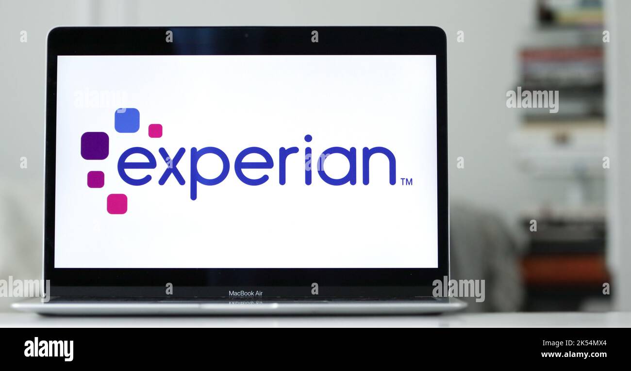 A logo design of experian on a laptop screen in blurred background ...