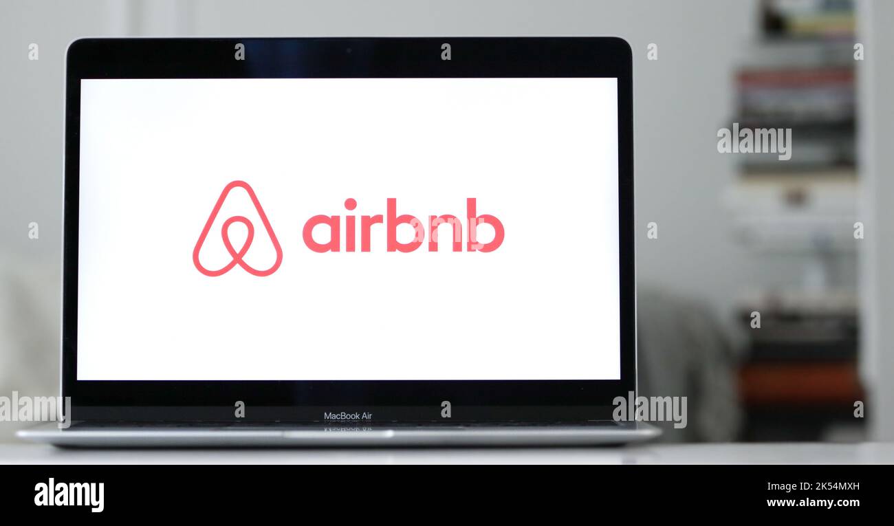 A logo design of airbnb on a laptop screen in blurred background Stock ...