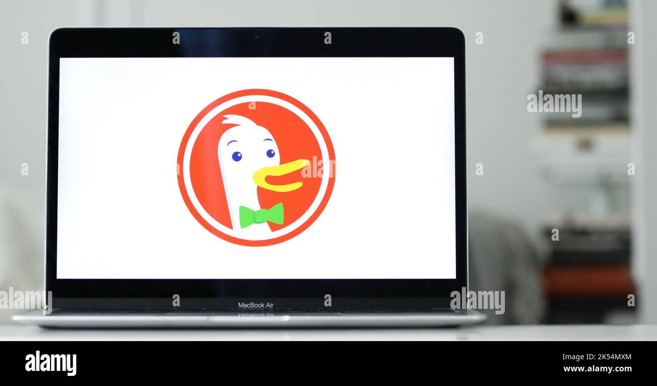 A logo design of DuckDuckGo on a laptop screen in blurred background ...