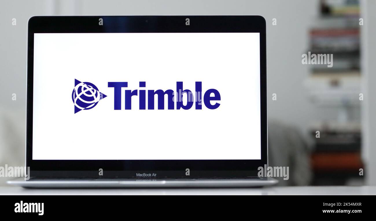 A logo design of Trimble on a laptop screen in blurred background Stock ...