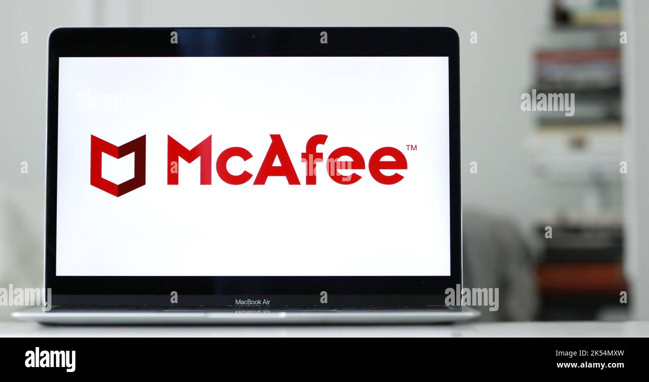 A logo design of McAfee on a laptop screen in blurred background Stock ...