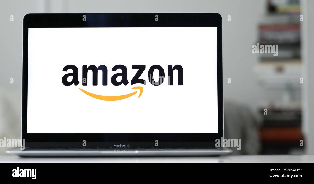 A logo design of Amazon on a laptop screen in blurred background Stock ...