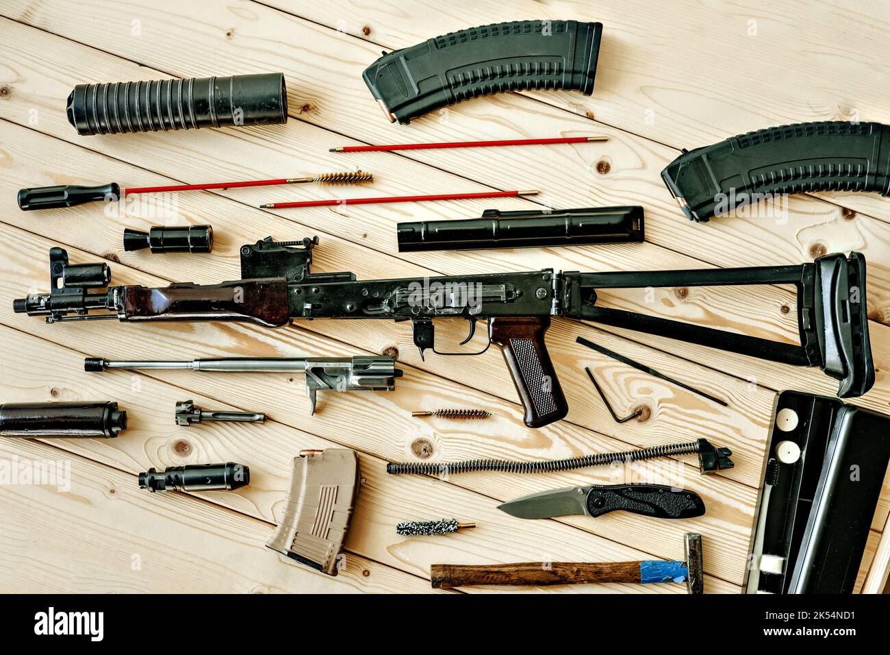 Disassembled rifle with cleaning tools on table of weapons workshop ...