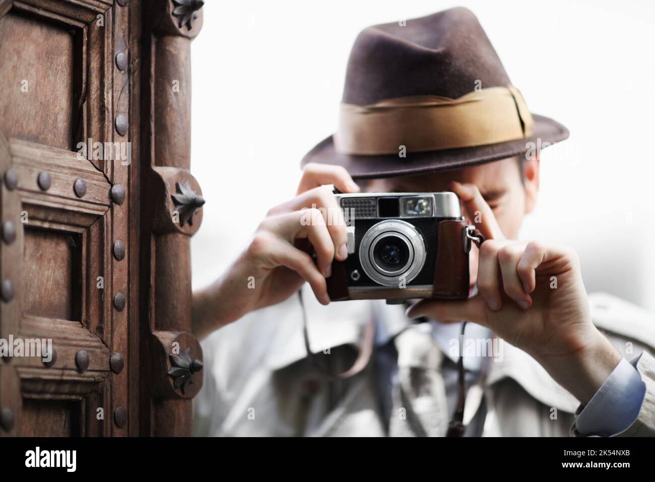 Say cheese. Detective capturing a photo from around the corner while ...