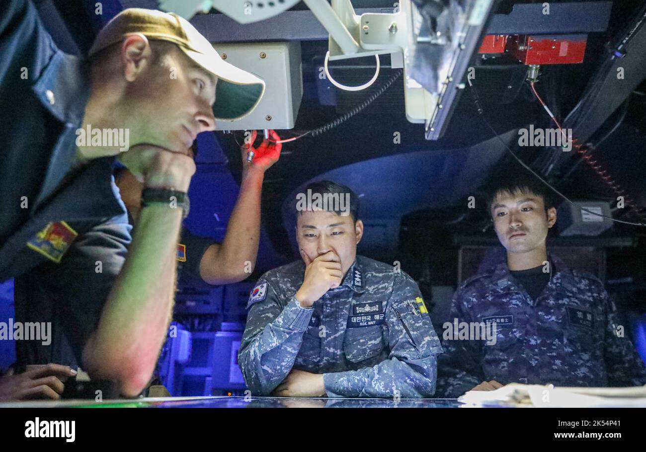 Cmdr. Marcus Seeger, left, commanding officer of the Arleigh Burke ...