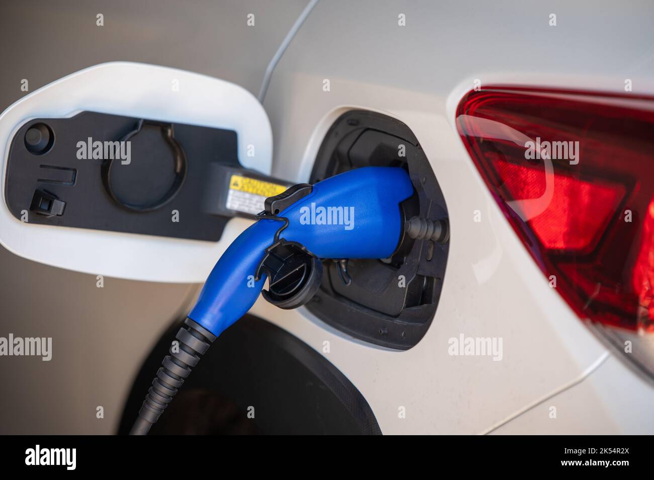 Close up shot of electric vehicle being charged Stock Photo - Alamy