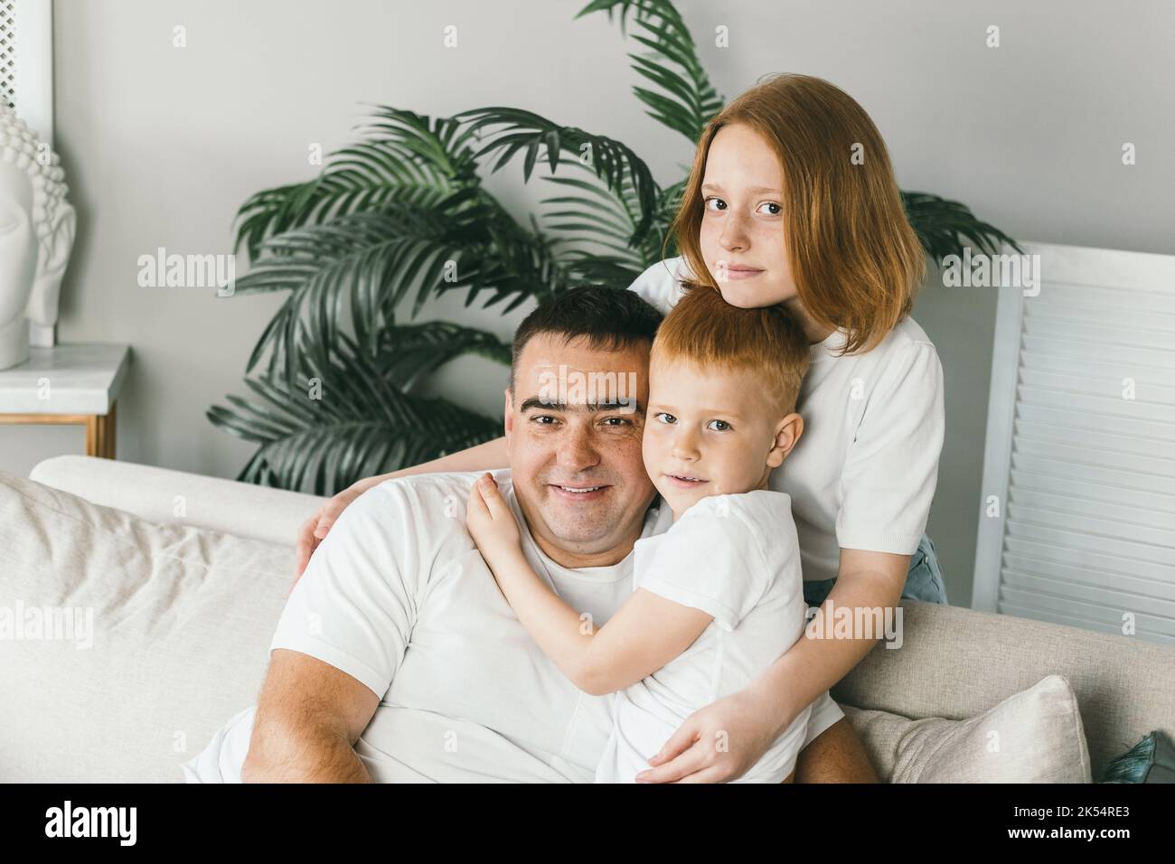 Brother and sister hug their father Stock Photo - Alamy