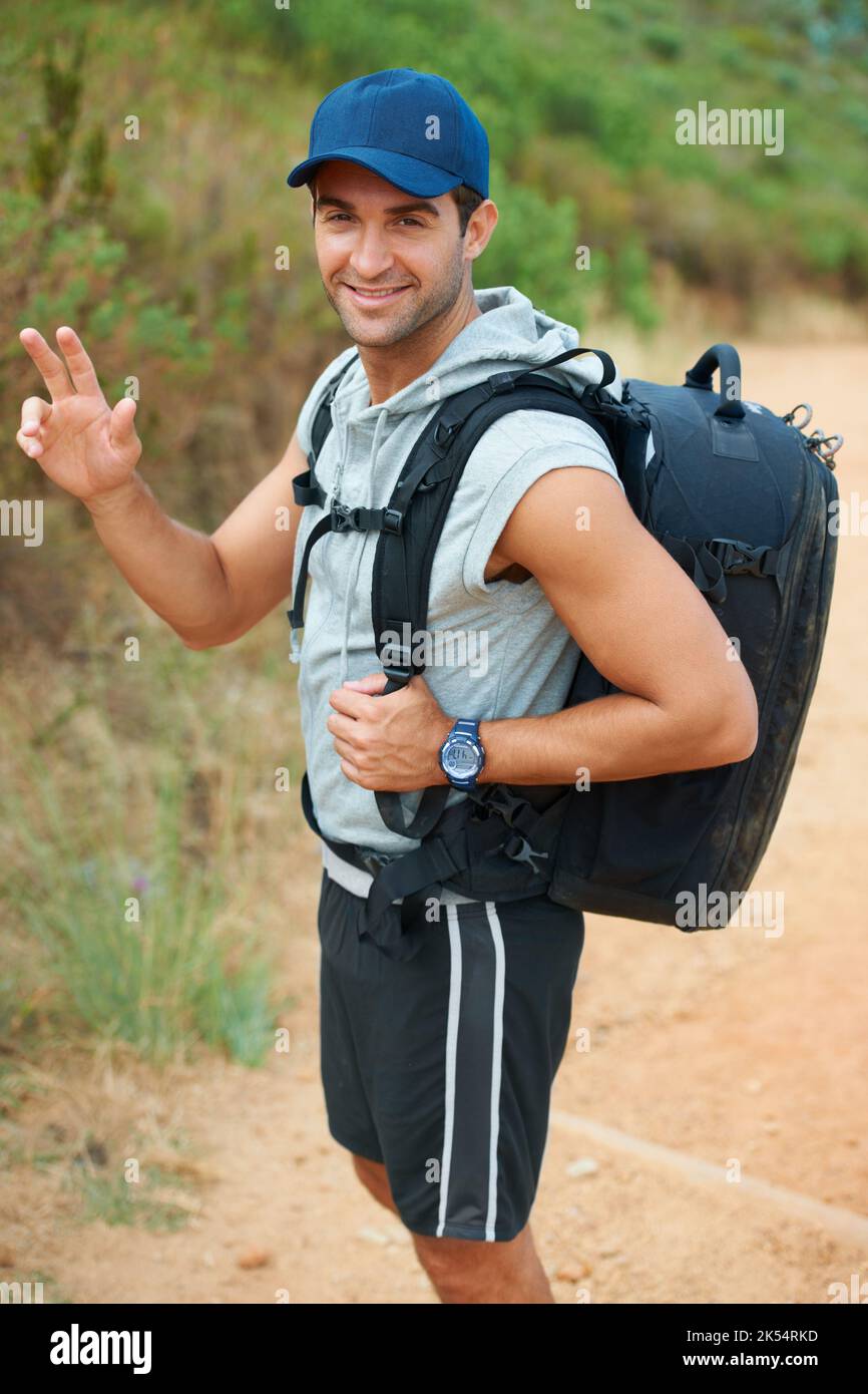 Waving wanderer. Handsome young hiker waving at the camera - portrait ...