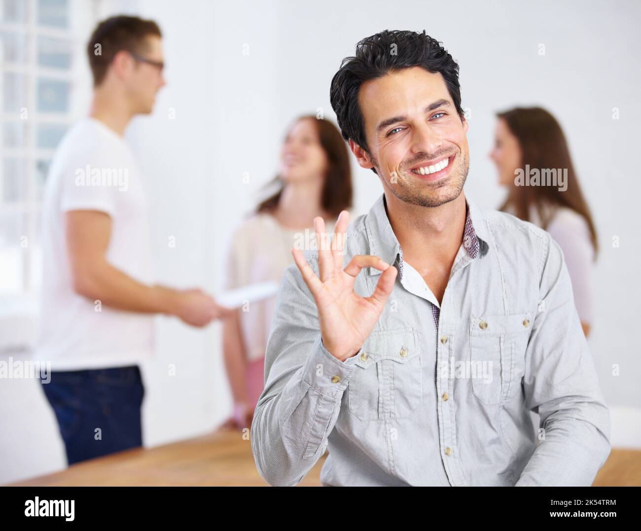 My teams doing great. Portrait of a young business professional giving ...