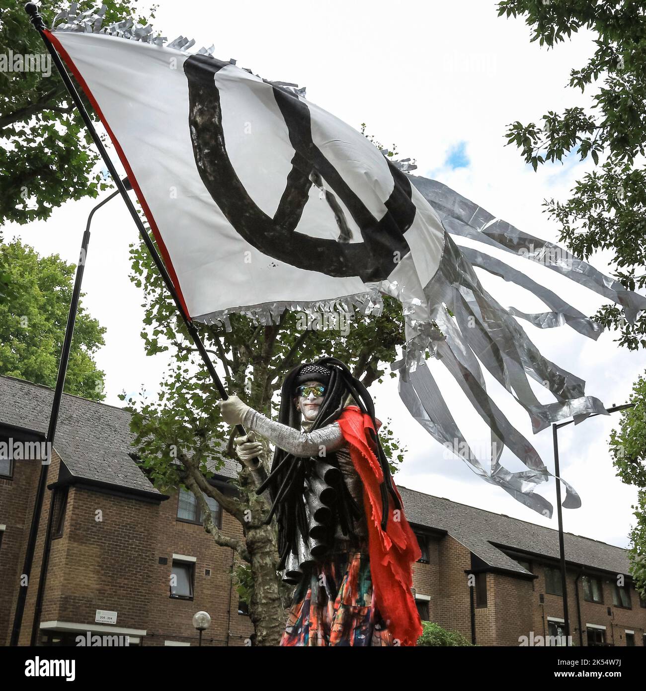 Stilt walker with peace sign flag at Notting Hill Carnival, London ...