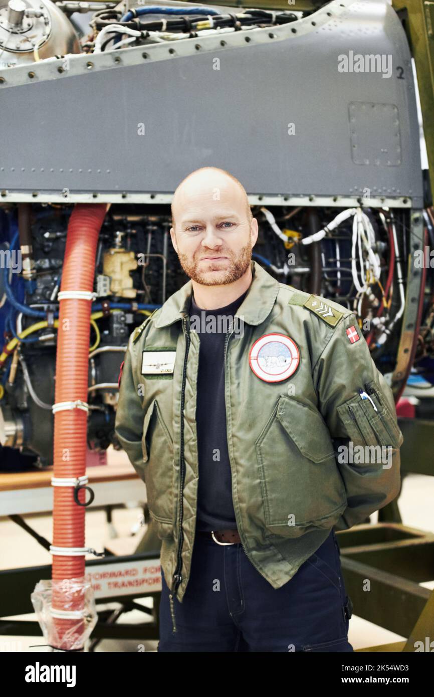 He knows the inner workings of a plane. Portrait of a pilot standing in ...