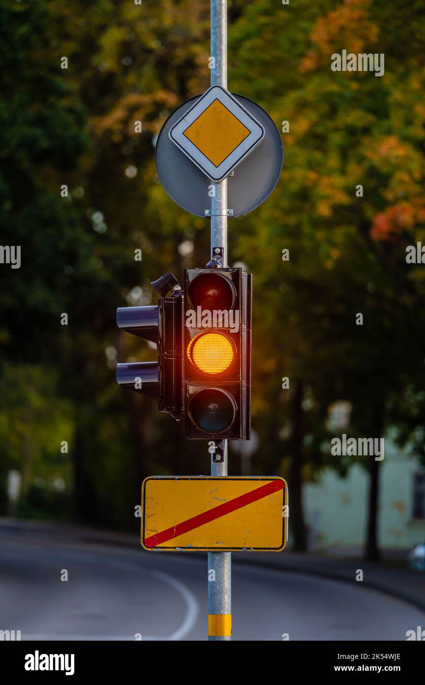 traffic semaphore with yellow light on defocused background of autumn city, close-up Stock Photo ...