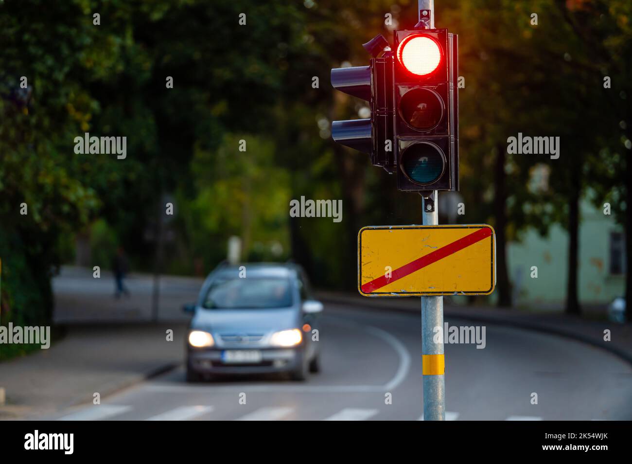traffic semaphore with red light on defocused background of autumn city ...
