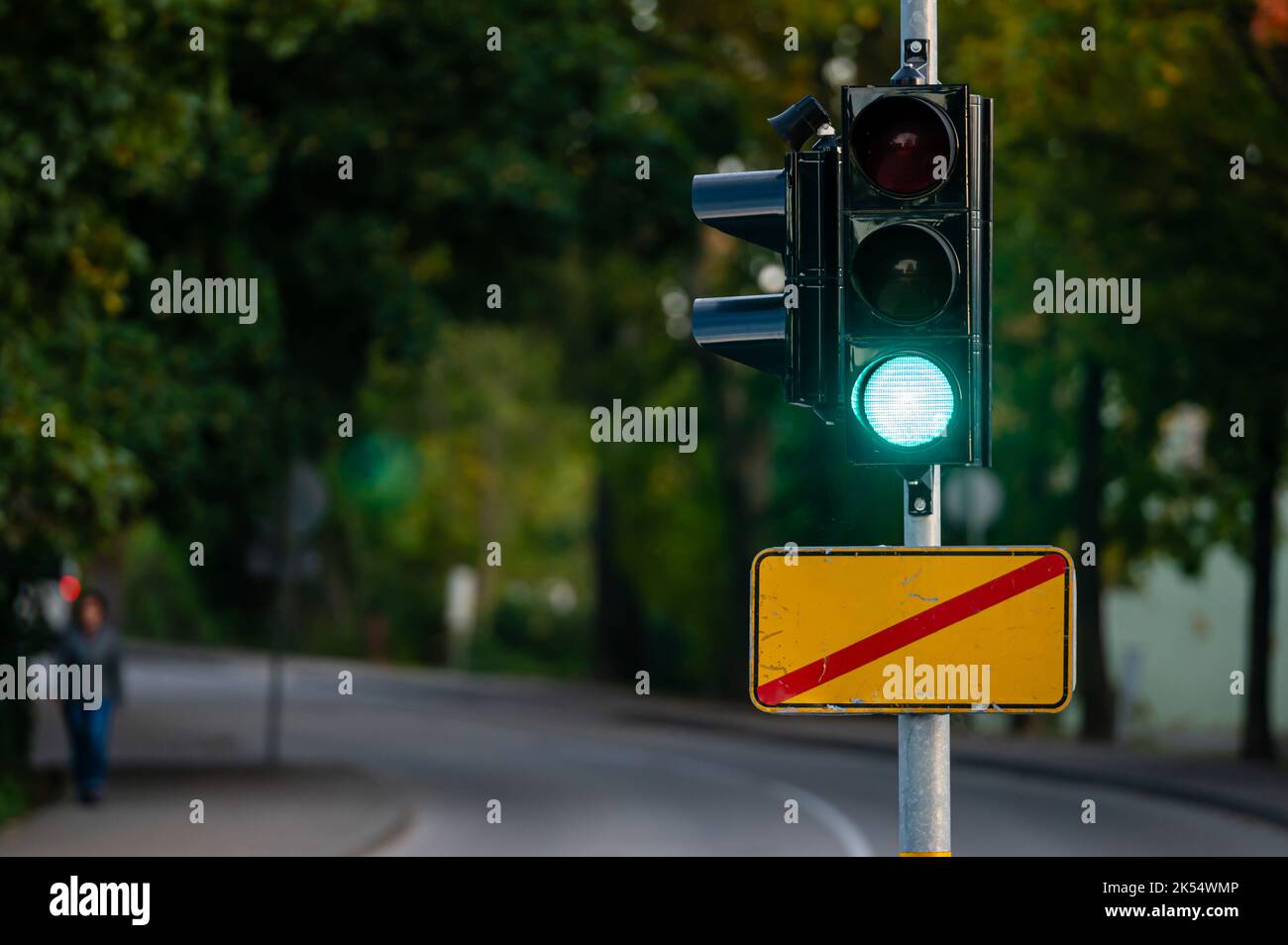 traffic semaphore with green light on defocused background of autumn ...