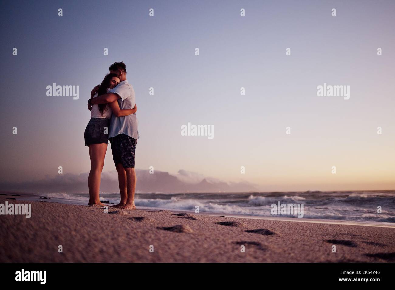 Love, beach and footprints in the sand with couple at sunset for ...