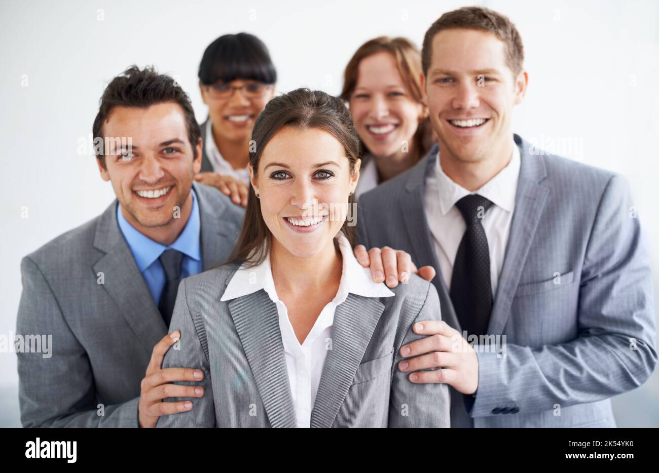 She sealed the deal. A group of businesspeople standing proudly with ...