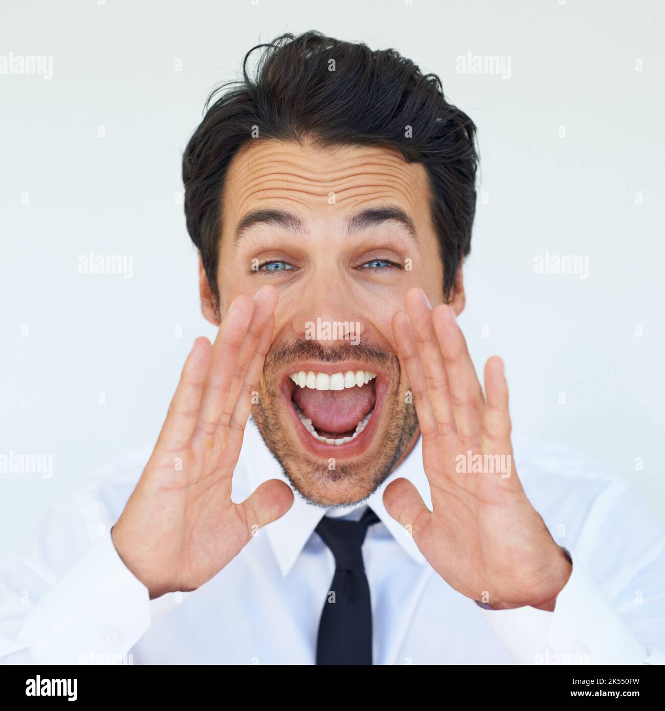 Shouting out his motto. A handsome businessman shouting at the camera ...