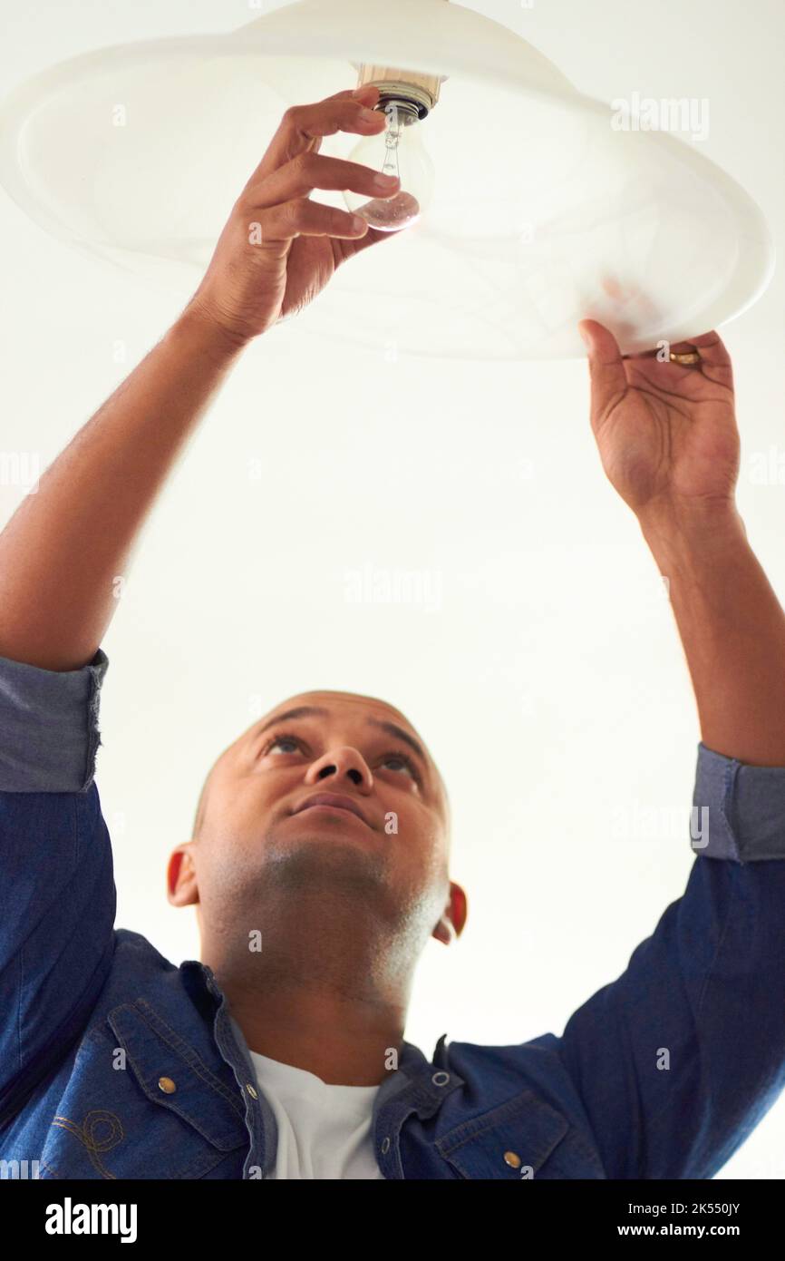 Home improvements is his middle name. an ethnic handyman changing a ...