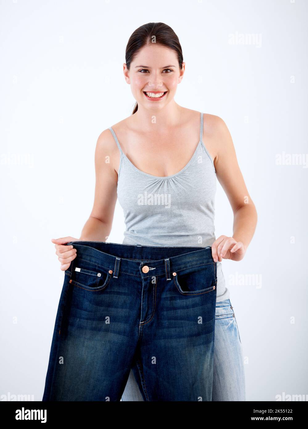 I feel so good about myself. A pretty, slim woman holding up a pair of ...