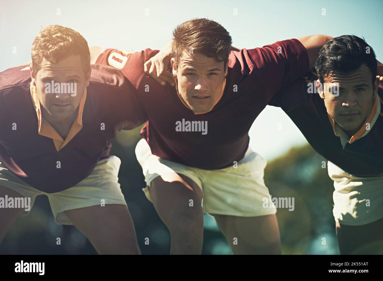 Crouch, touch, pause, engage. Portrait of a young rugby team lining up ...