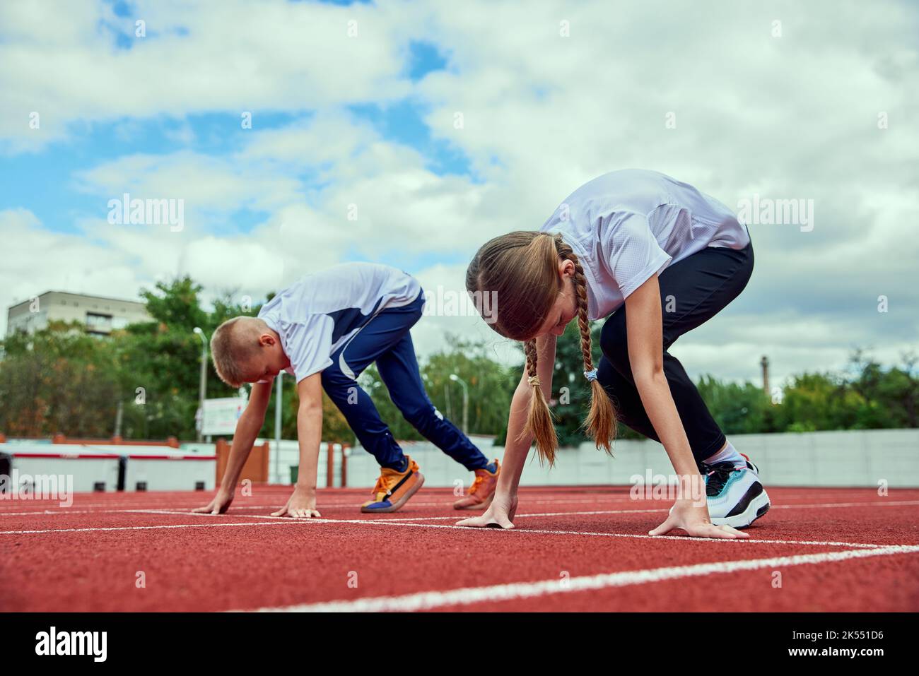 Start. Group of kids getting ready to run on treadmill at the stadium ...
