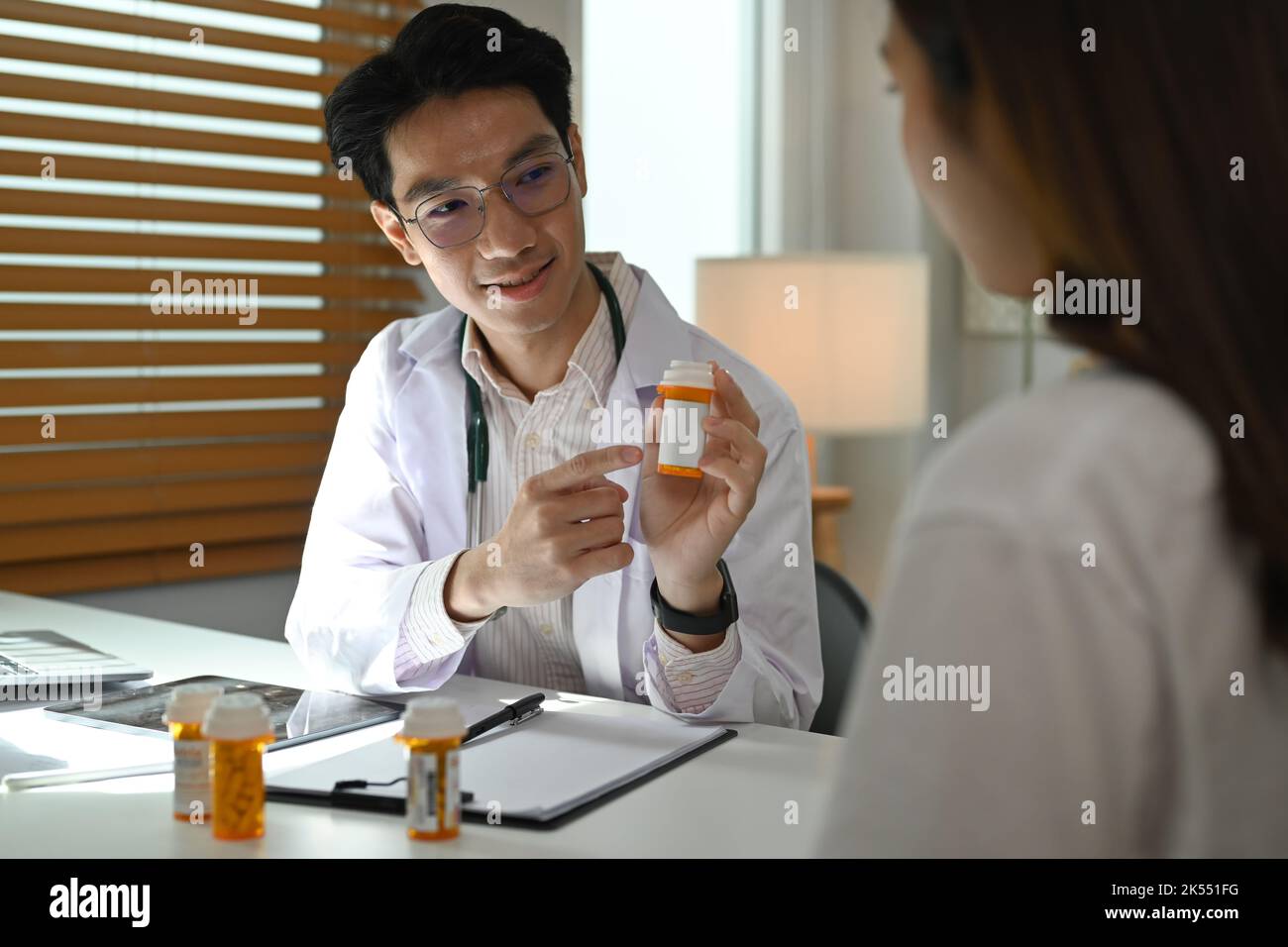 Smiling doctor explaining medicine dosage to o patient. Medicine ...