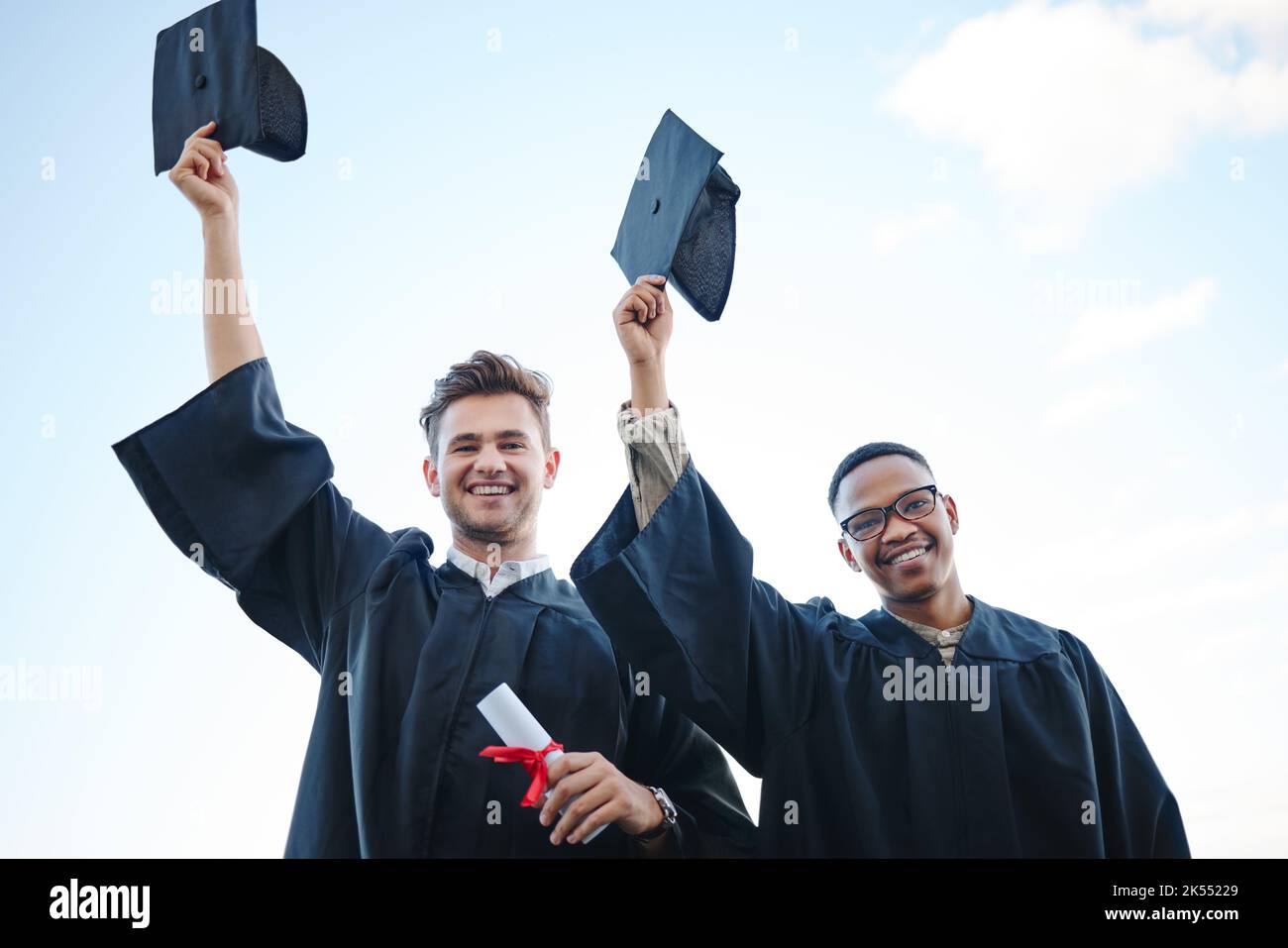 Graduation, education and students with blue sky happy with success in ...