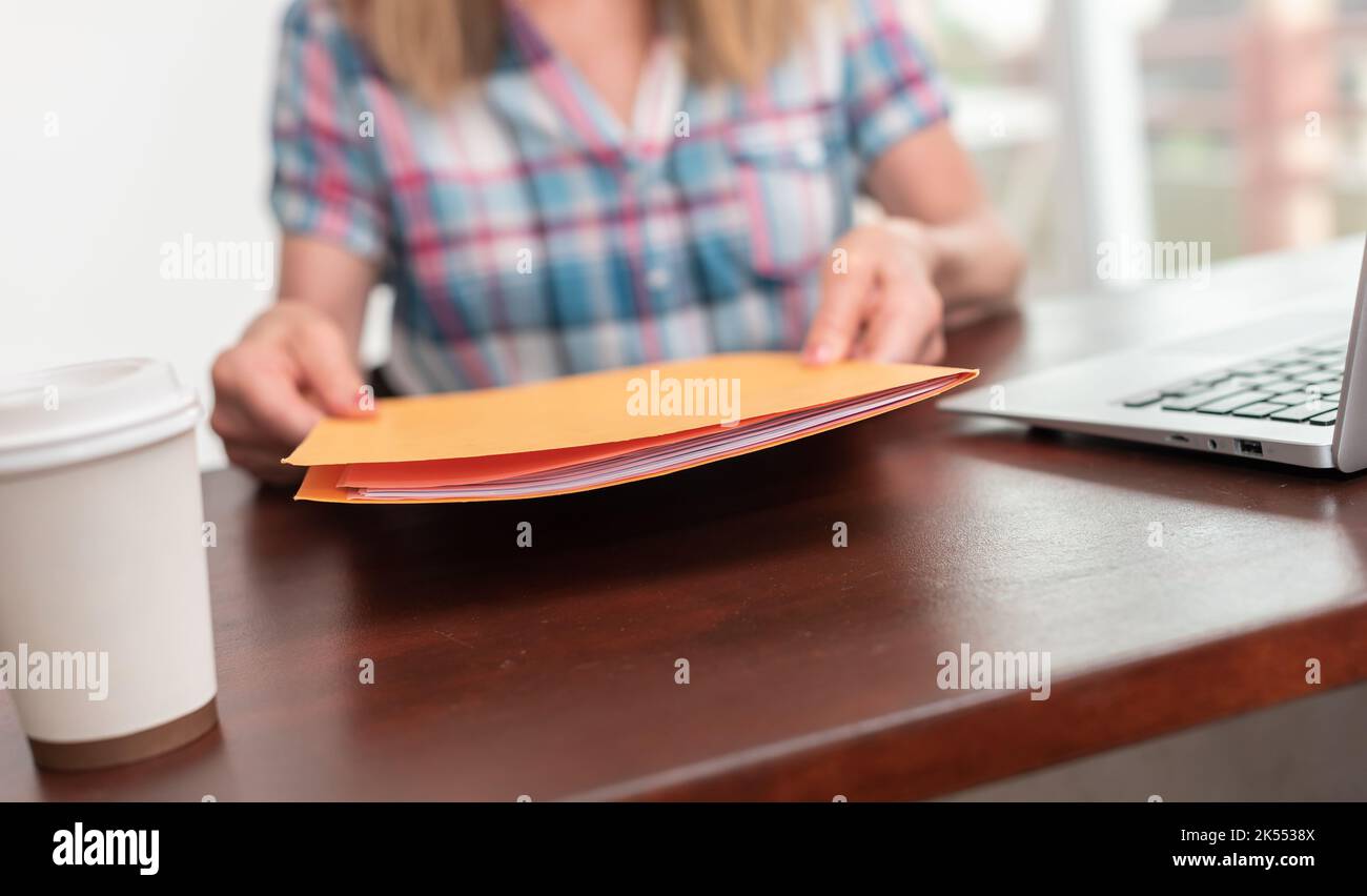 Businesswoman holding folder with paper documents Stock Photo - Alamy