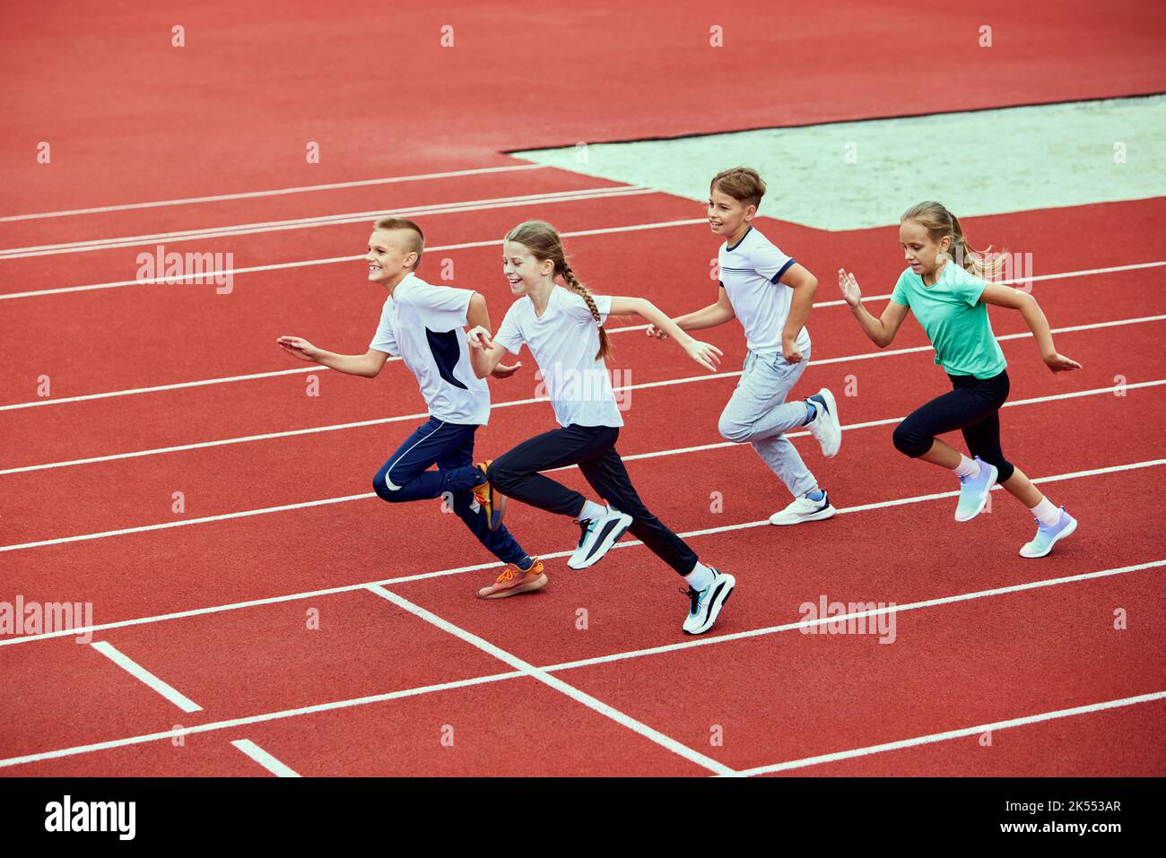 Group of children running on treadmill at stadium or arena. Little fit ...
