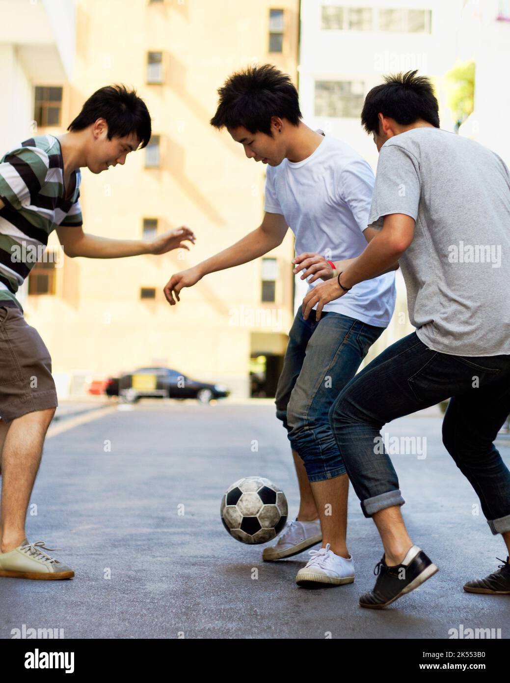 Taking on all competitors. a young people playing football in the ...