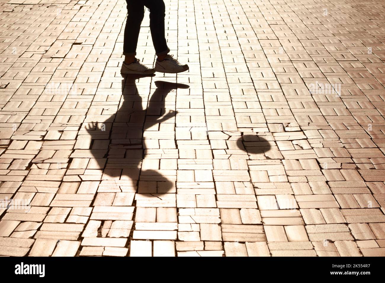 Kicking it by myself. Cropped image of a single pair of legs kicking a ...