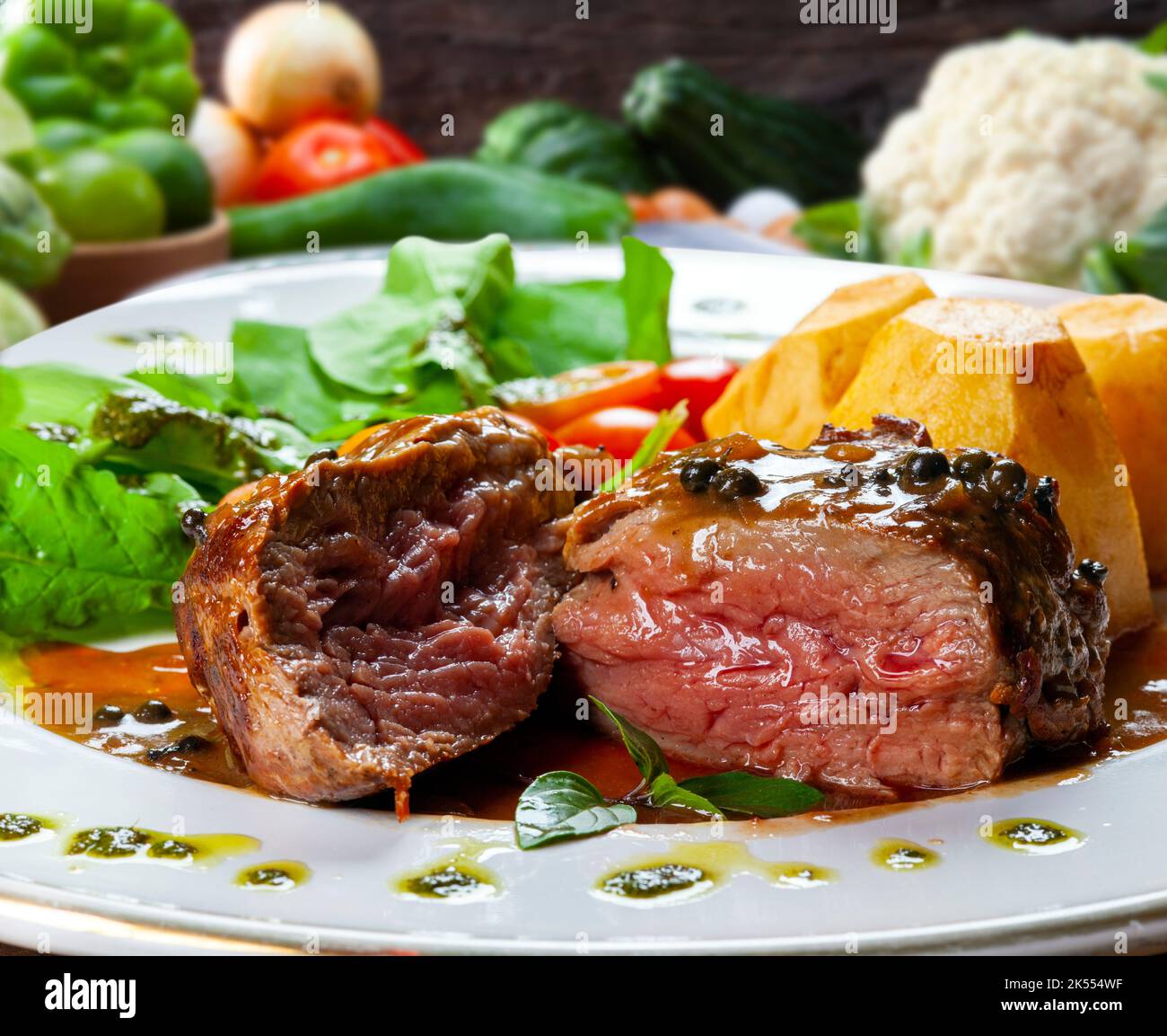 Filet mignon steak with sauce, salad and potato Stock Photo - Alamy