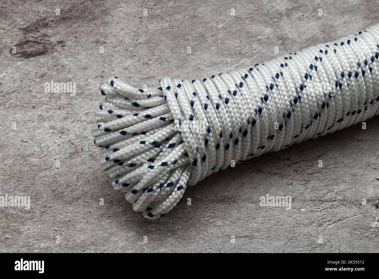 White braided polypropylene rope 16 strands isolated on concrete ...
