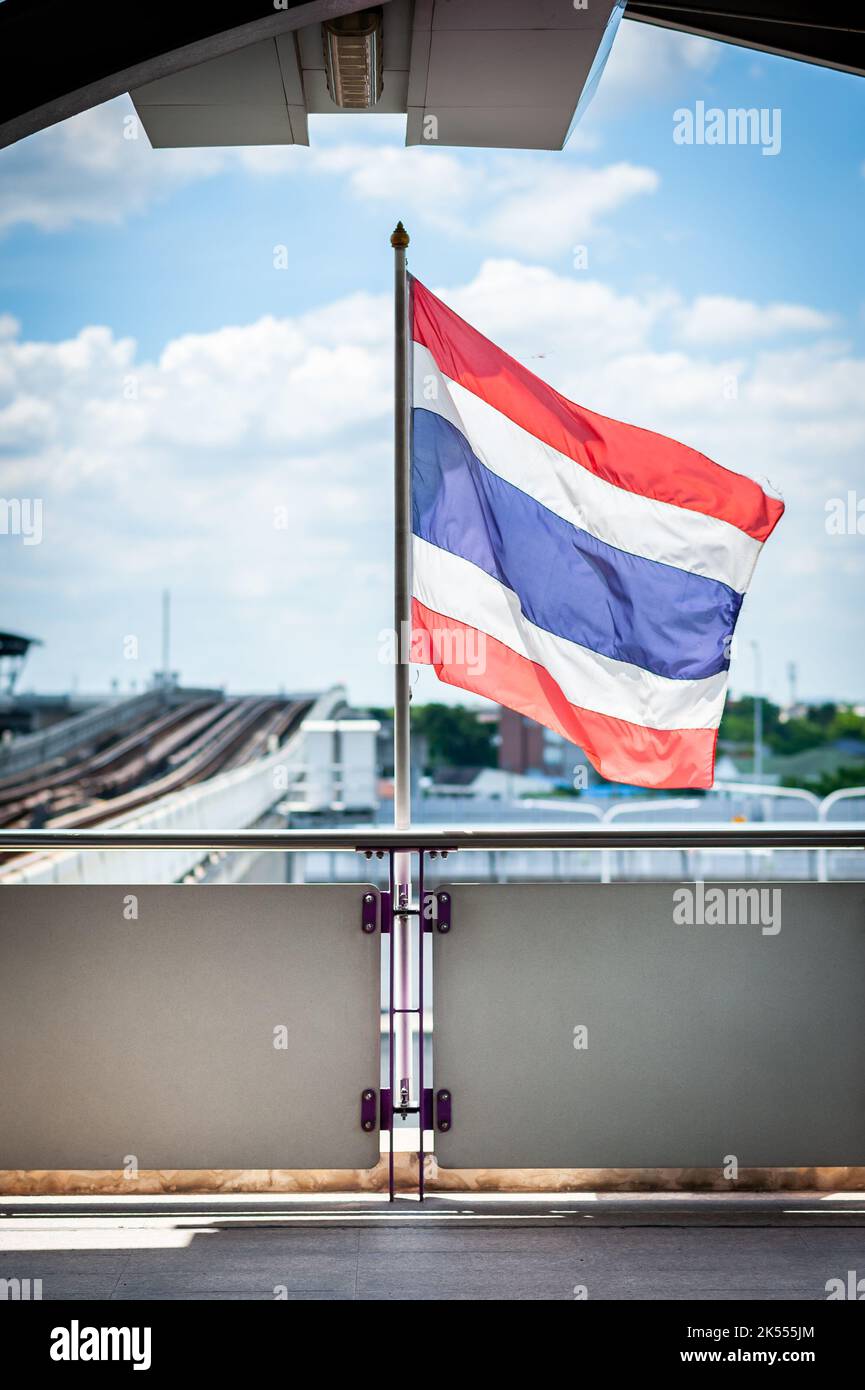 The Thai national flag flies in the wind on the platform of one of ...