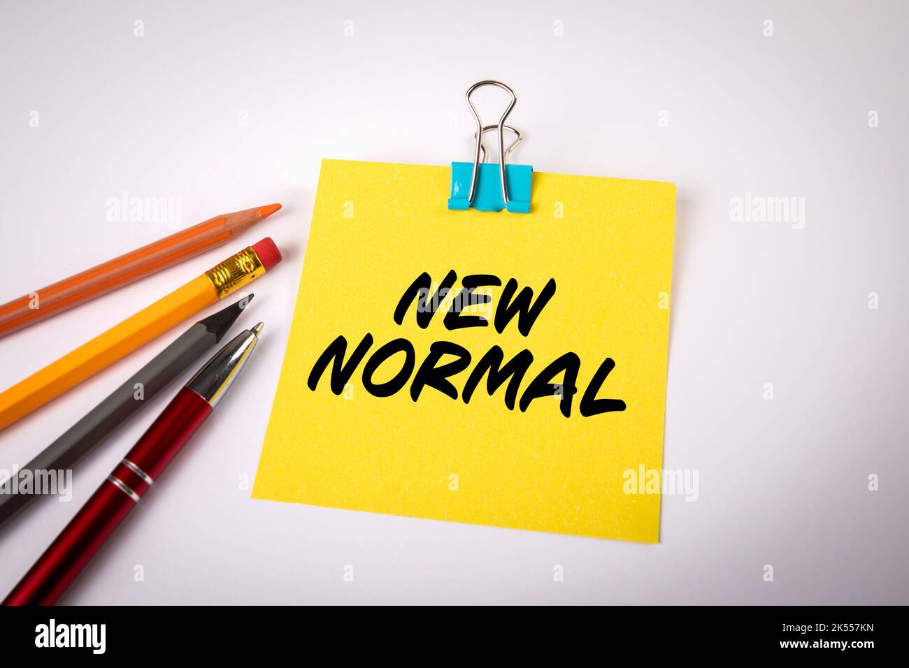 New Normal. Text on a yellow sheet of paper. White office desk Stock ...