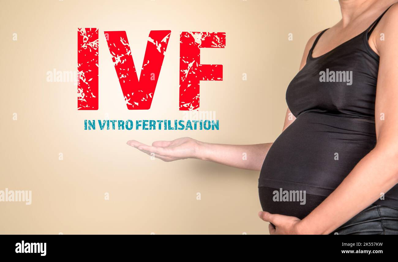 IVF In vitro fertilisation. Pregnant woman pointing to text Stock Photo ...