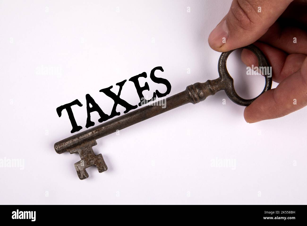 Taxes, Business and Development concept. Old door key on a white ...